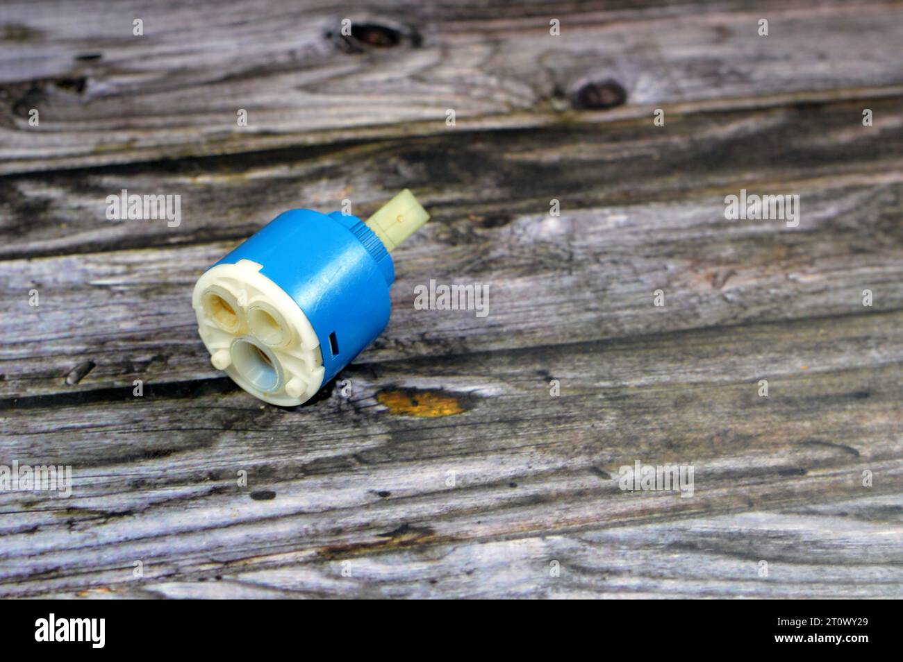 A used broken shower faucet tap body cartridge parts of plastic that ...