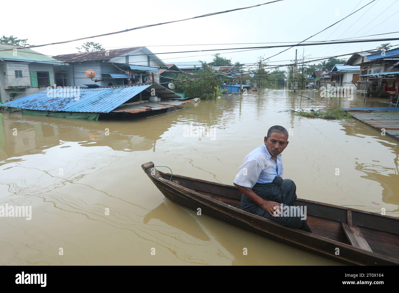 Bago, Myanmar. 9th Oct, 2023. A man takes a boat at a flooded area in ...