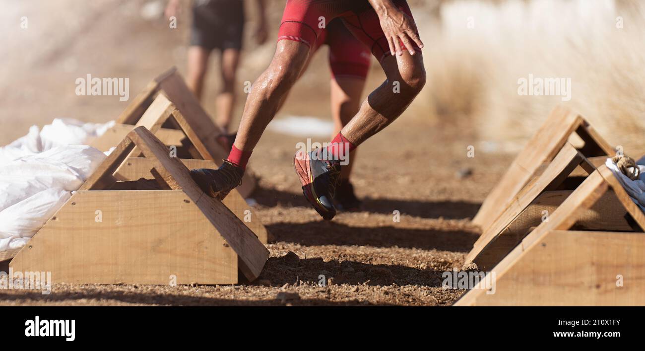 Mud race runners during extreme obstacle race Stock Photo - Alamy
