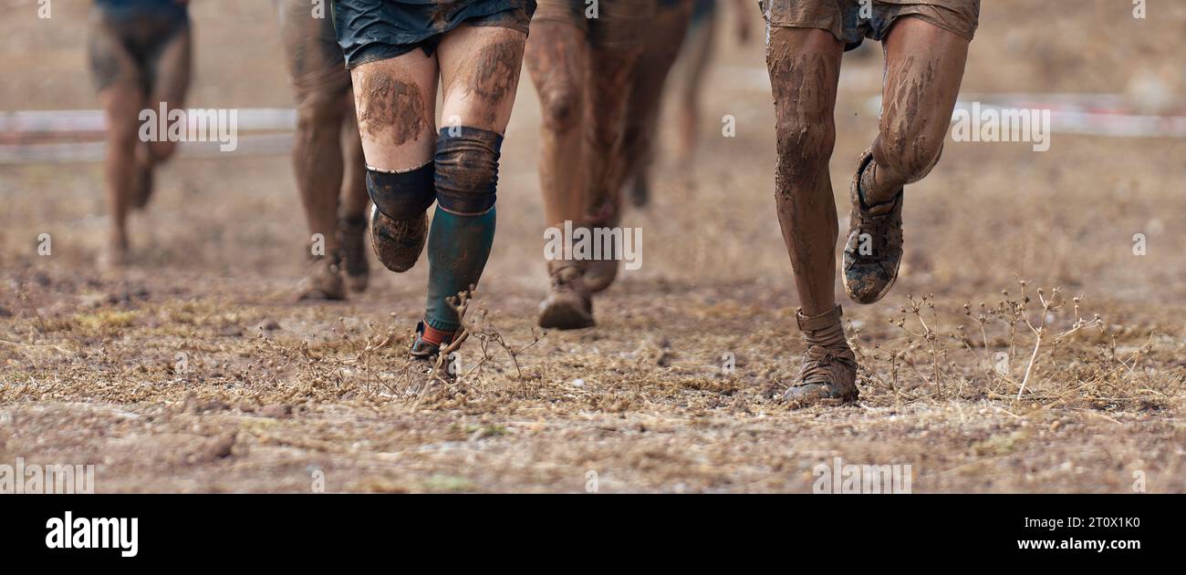 Group of participants in an obstacle course race running. They run very ...