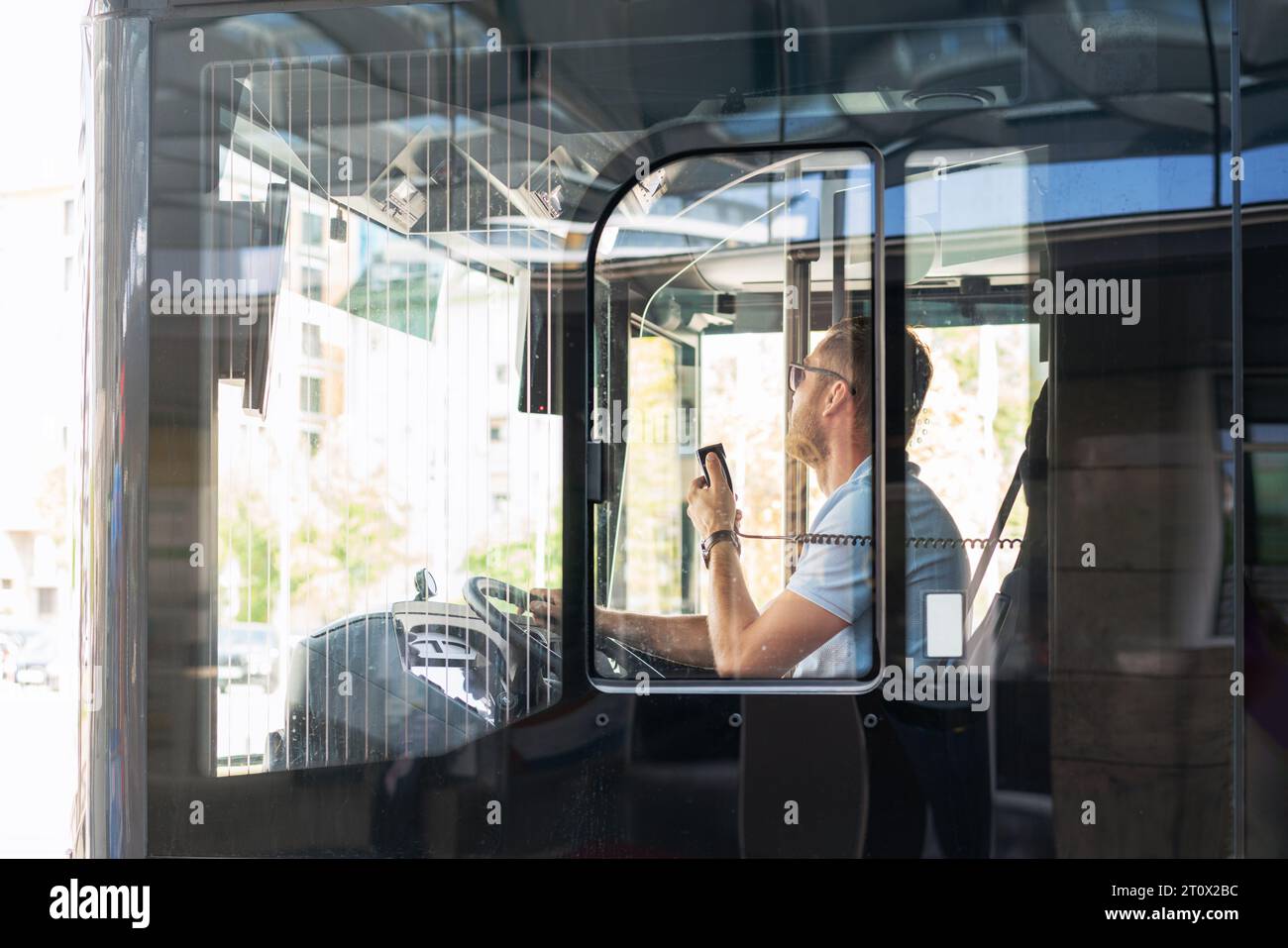 Bus driver occupation. The male bus driver makes an announcement to ...