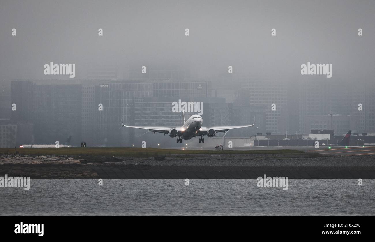 An aircraft ascending from a runway in the Boston area, with the ...