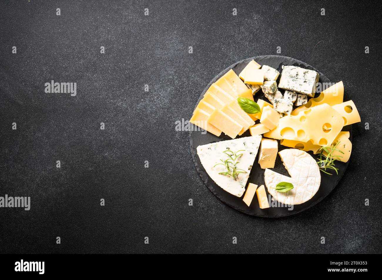 Cheese platter with craft cheese assortment at black background Stock ...