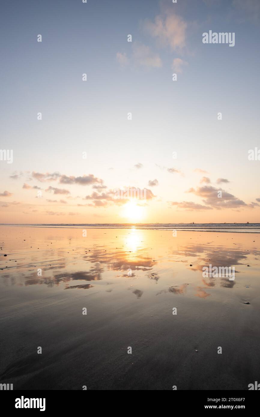Dreamlike sunset on the dream beach of Kuta, small waves sunset over ...