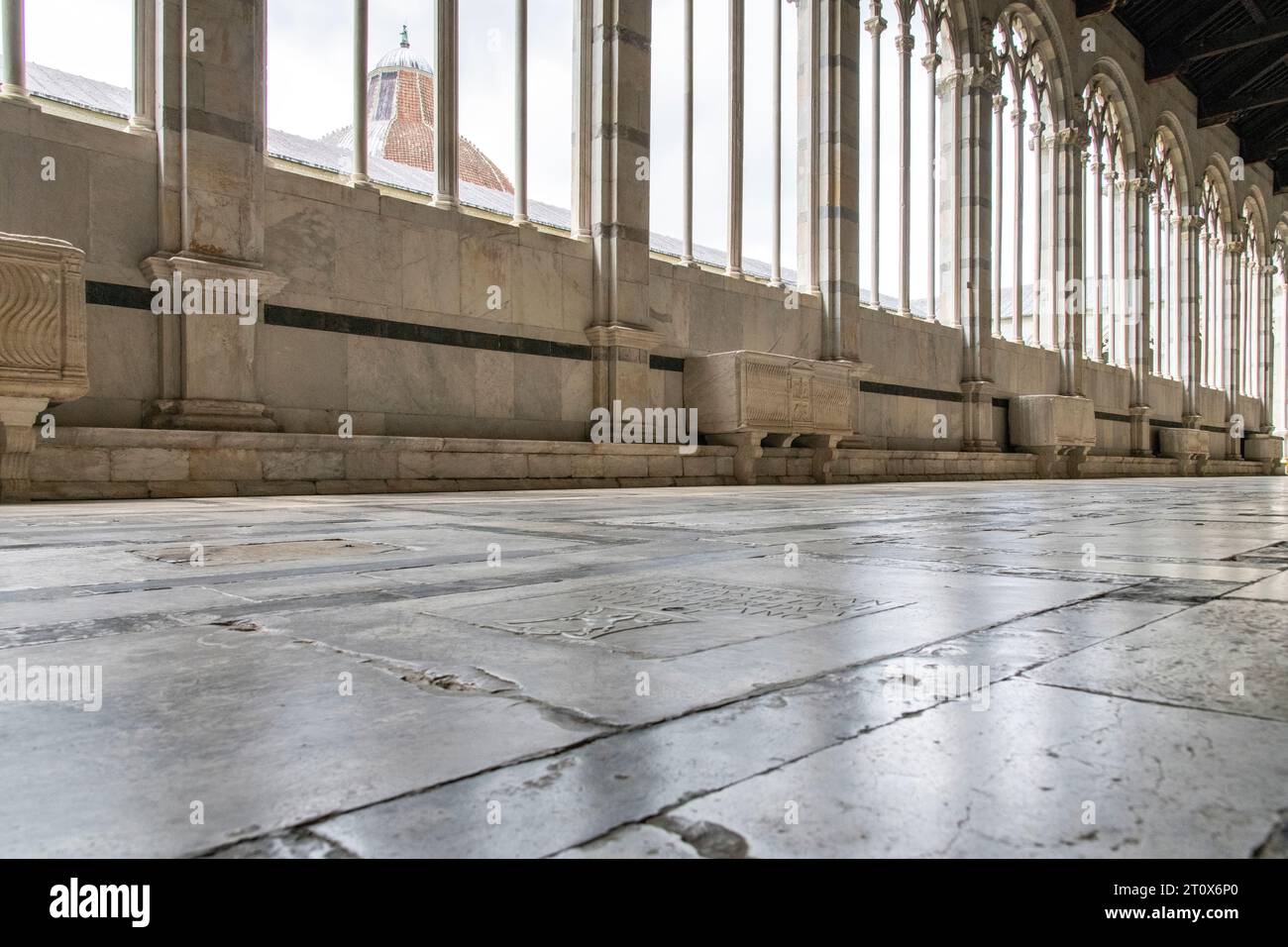 Low angle view of grave stones in covered walkway of The Campo Santo or ...