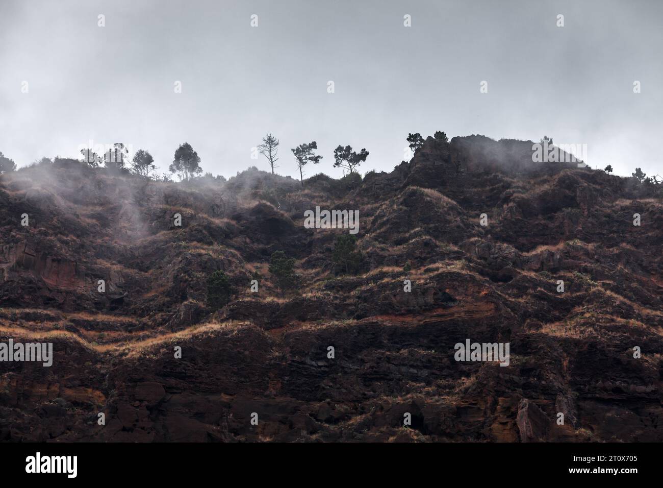 Dark coastal landscape with red rocks of Madeira island, Portugal Stock ...