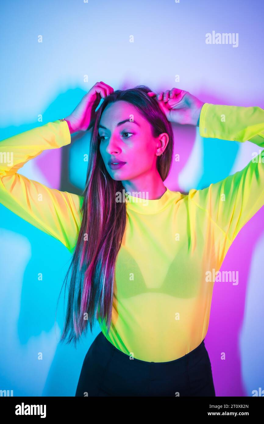 Party lifestyle in a nightclub with pink blue neon lights, portrait of ...