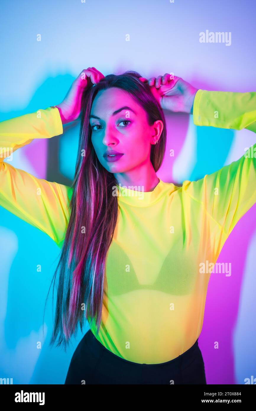 Party lifestyle in a nightclub with pink blue neon lights, portrait of ...