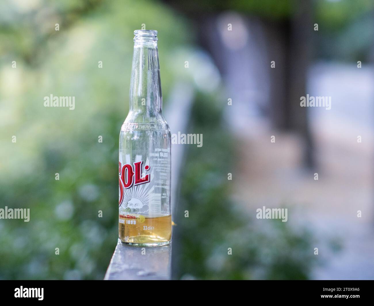 Sol beer, half-empty bottle on a fence, Leoben, Styria, Austria Stock ...