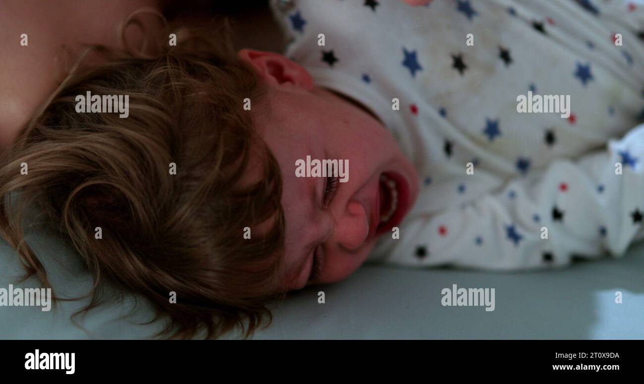 Angry baby not wanting to brush teeth, upset infant boy showing ...