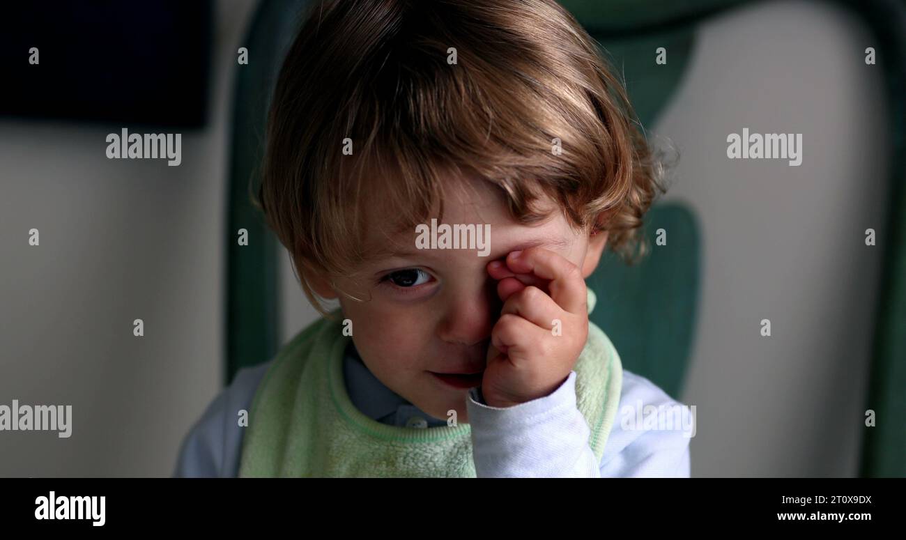 Baby rubbing eyes with hand. Cute toddler boy Stock Photo - Alamy