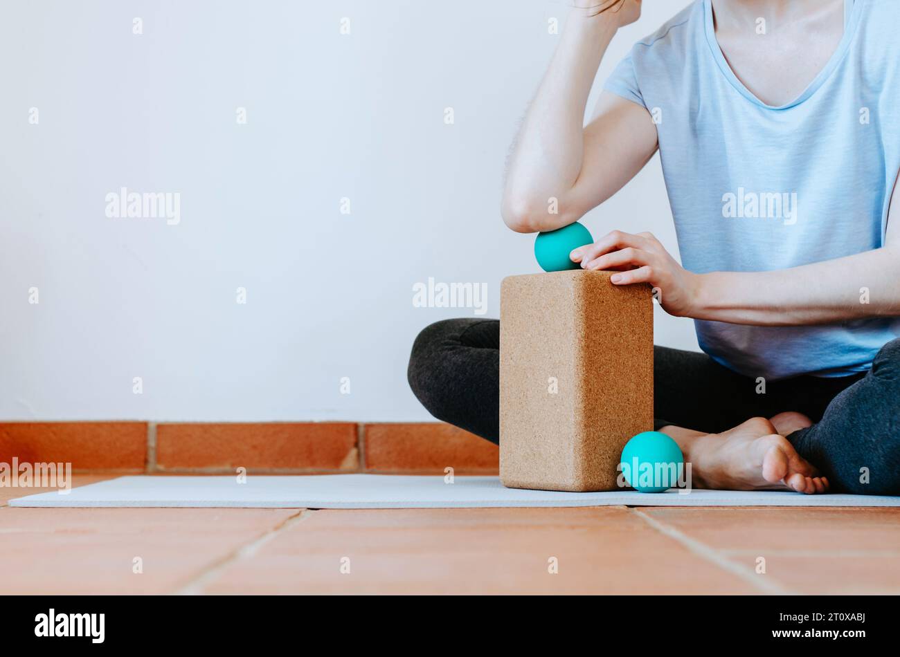 Woman doing triceps MFR with therapy ball and block Stock Photo - Alamy