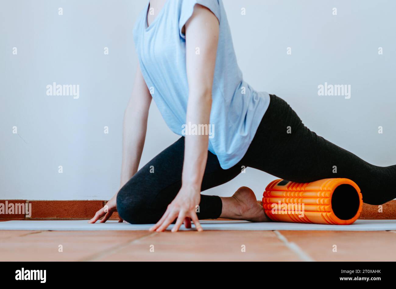 Quadriceps self myofascial release with foam roller Stock Photo - Alamy