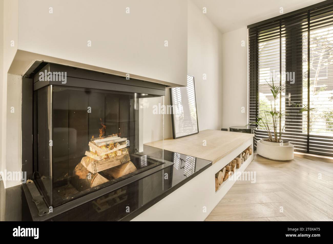 a modern living room with wood flooring and an open fire place in the ...