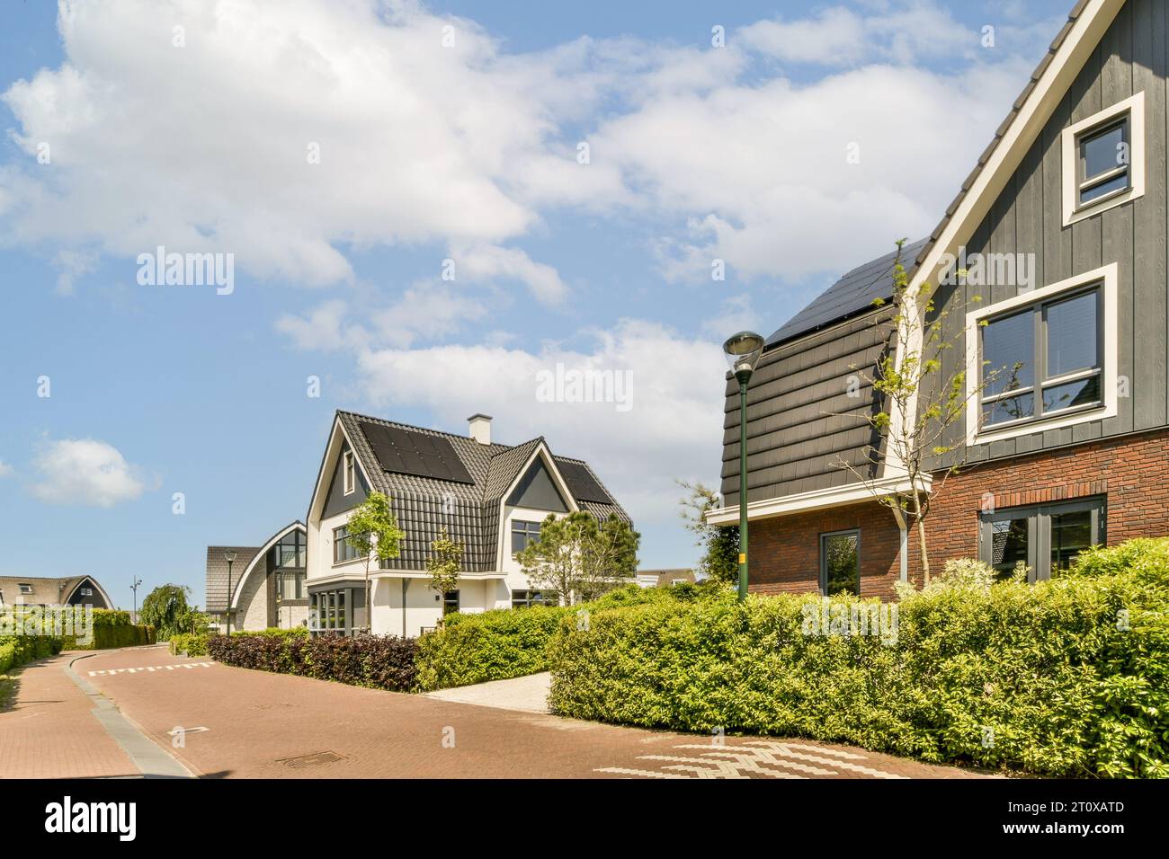 some houses in the country side with blue sky and white clouds above ...