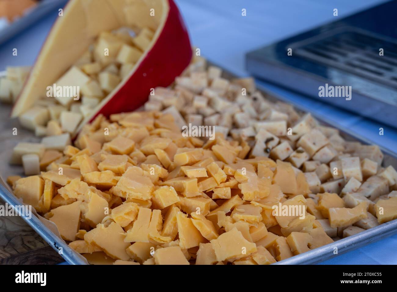 Party guests have appetizing bite size slices of cheese set up on a ...