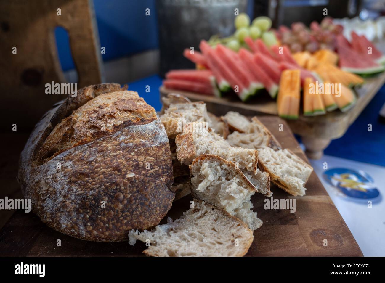 Party guests have appetizing sliced and broken bread set up on a buffet ...