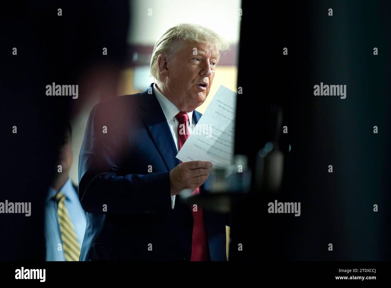 Former President Donald Trump holds papers moments before stepping on ...