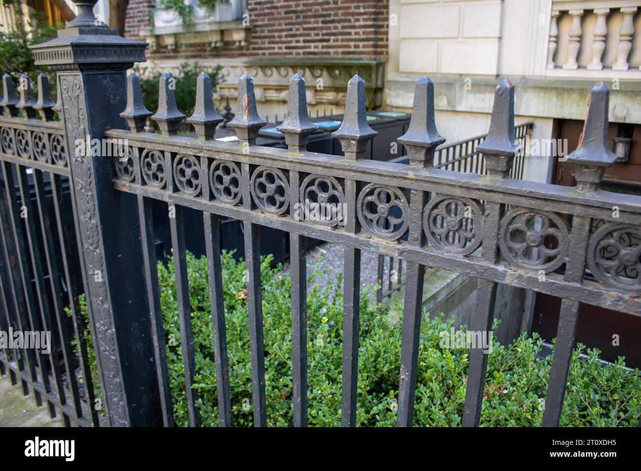 A scenic view of green plants behind a fence in a city Stock Photo - Alamy