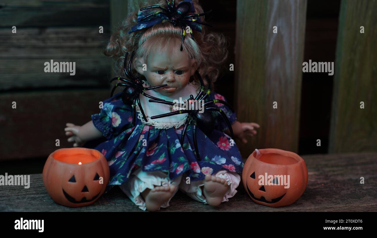 Afraid baby doll with spiders on it. Halloween decoration Stock Photo ...