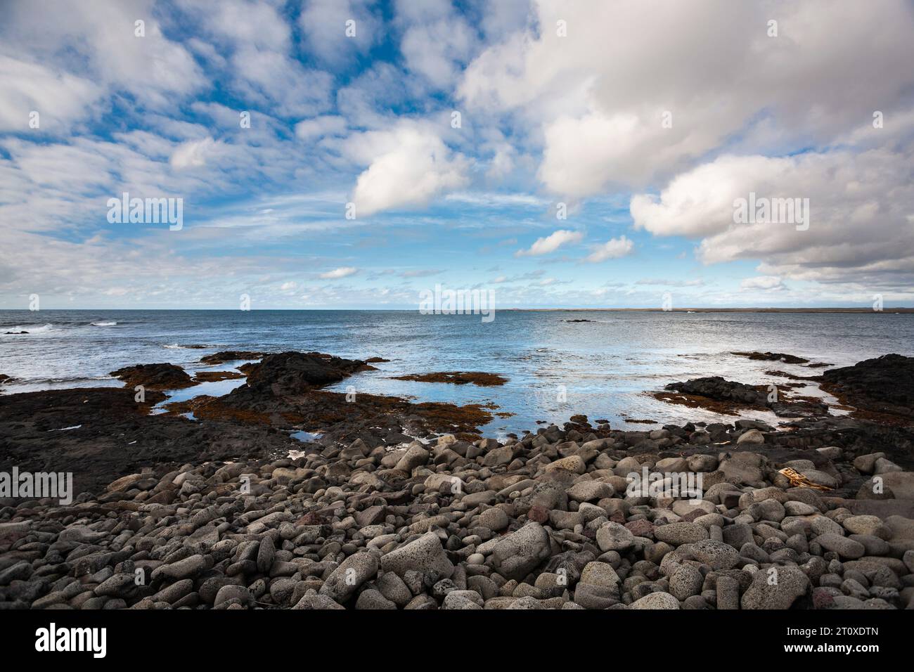 Rocky beach and puffy clouds, Hafnir, Suðurnes, Iceland Stock Photo - Alamy