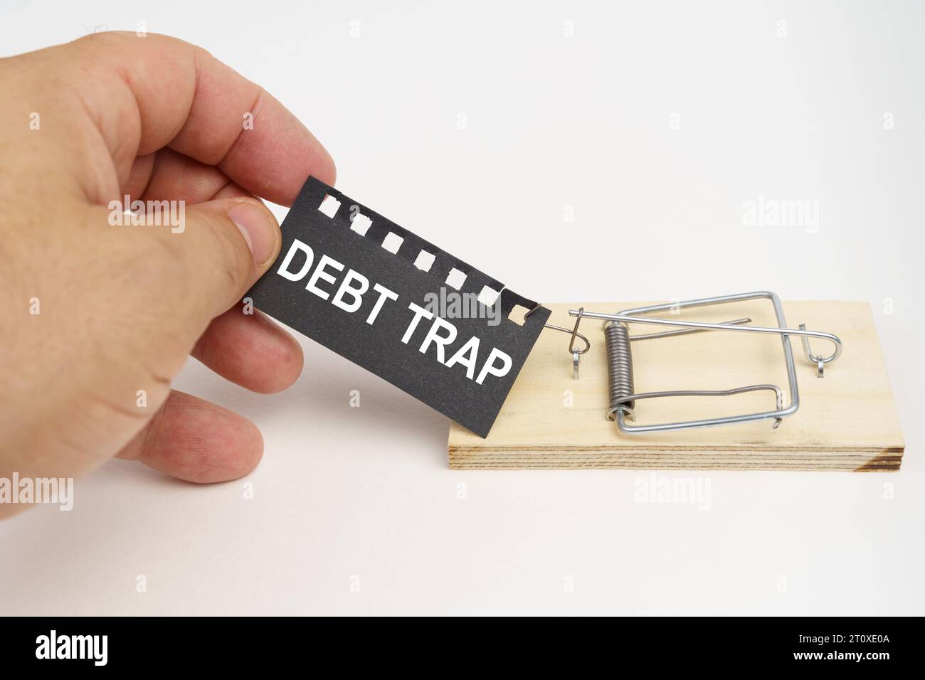 A man pulls the bait from a mousetrap. Bait, a sheet of black paper ...