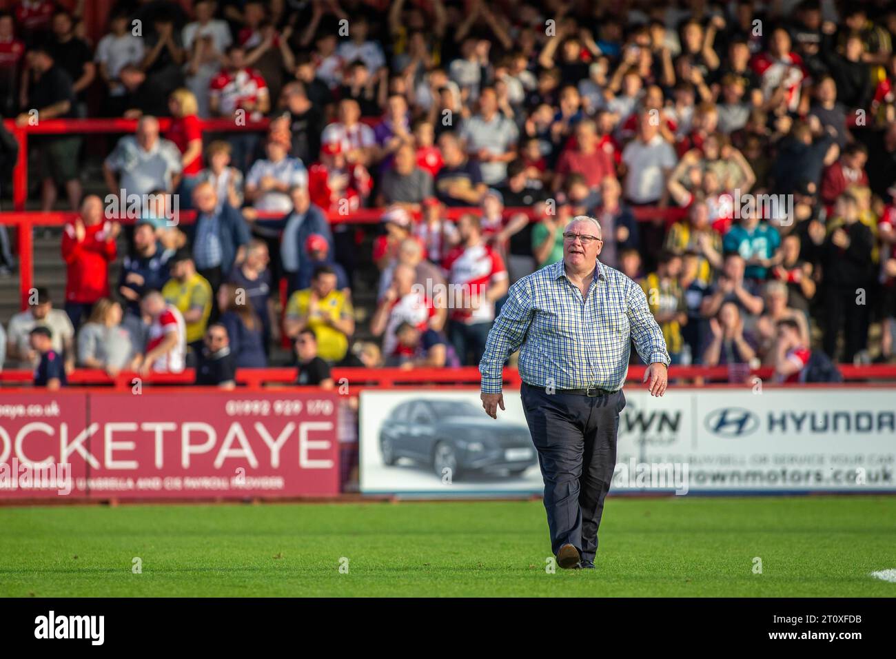 Football manager Steve Evans on pitch in front of fans and supporters ...