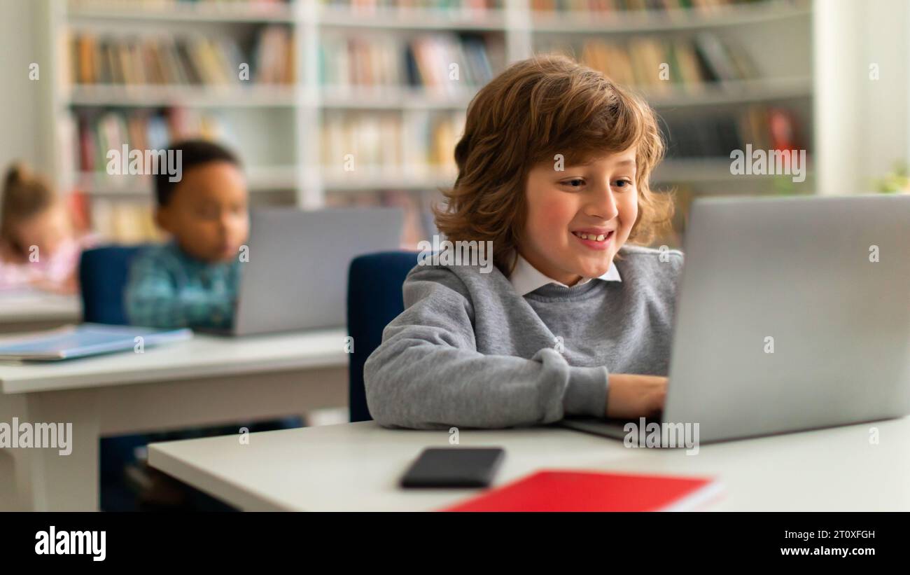 School children studying with laptops in classroom Stock Photo - Alamy