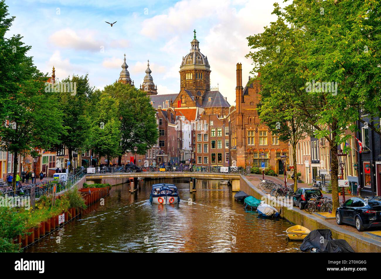 Amsterdam with a canal, bridges and boats. Beautiful old buildings ...