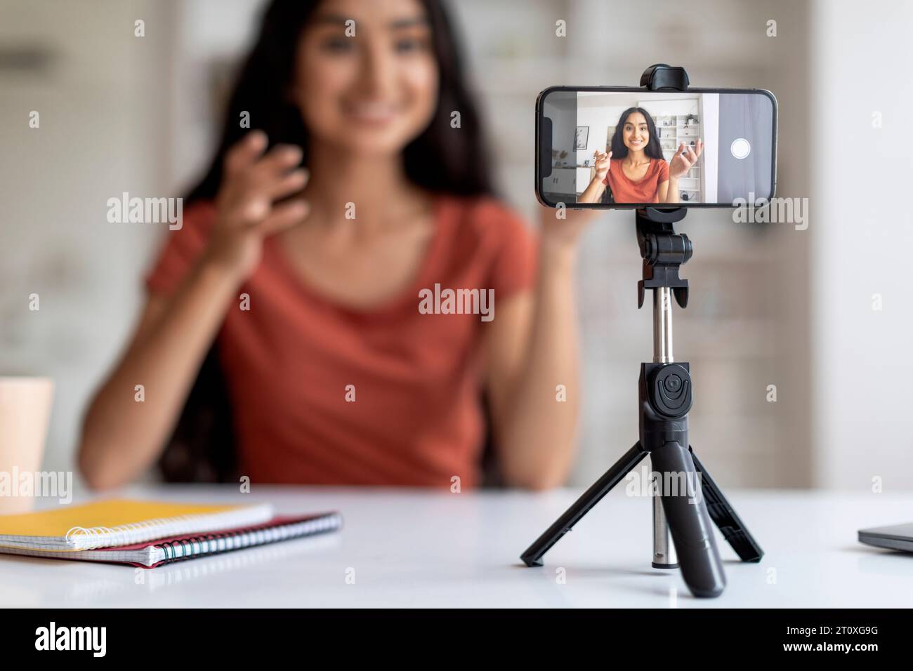 Phone on tripod recording millennial indian lady influencer Stock Photo ...
