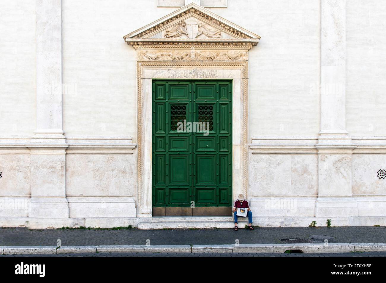 Rome, Italy-June 11, 2023; Man reading newspaper sitting on steps in ...