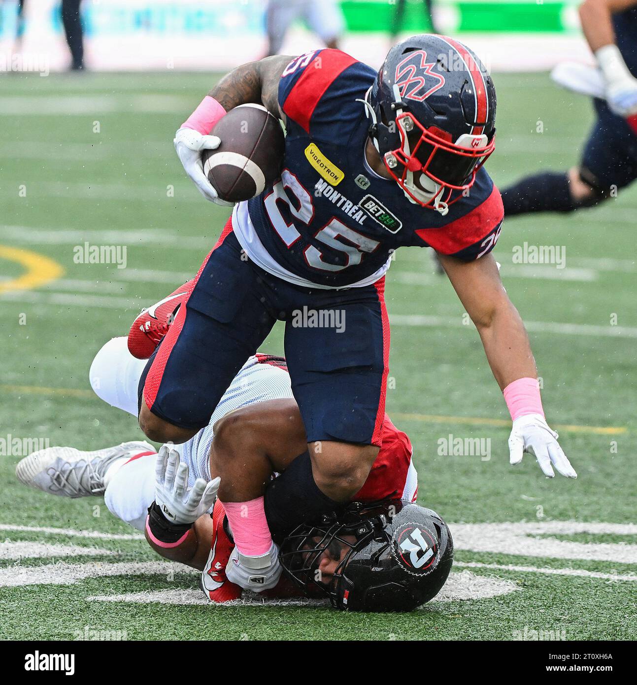 Montreal Alouettes' Walter Fletcher (25) is tackled by Ottawa Redblacks ...