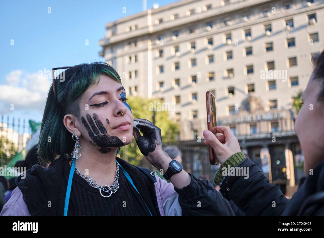 Buenos Aires, Argentina, oct 5, 2023: young woman painting herself with ...