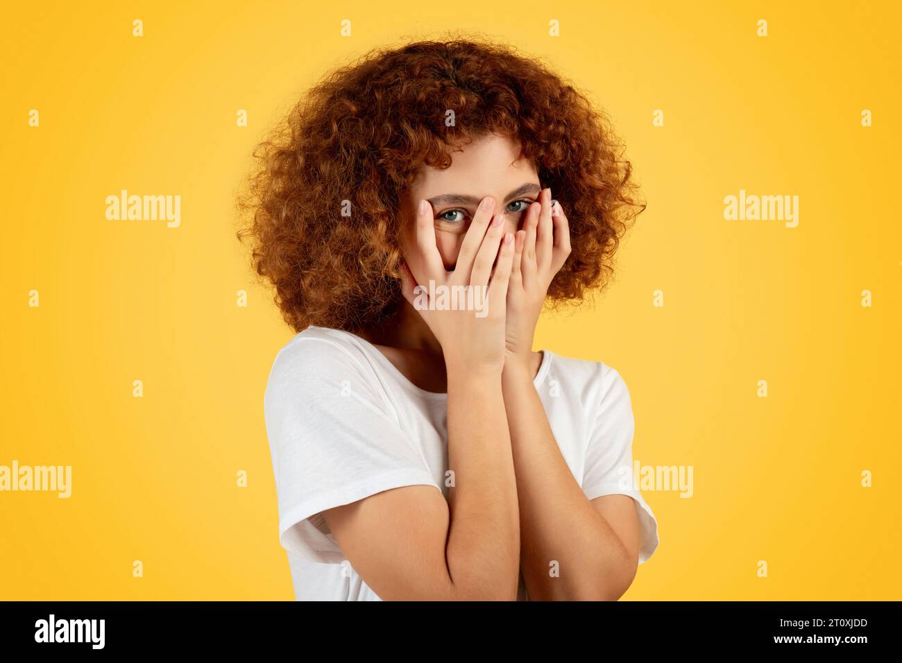 Embarrassed teen woman covers her face with hands Stock Photo - Alamy