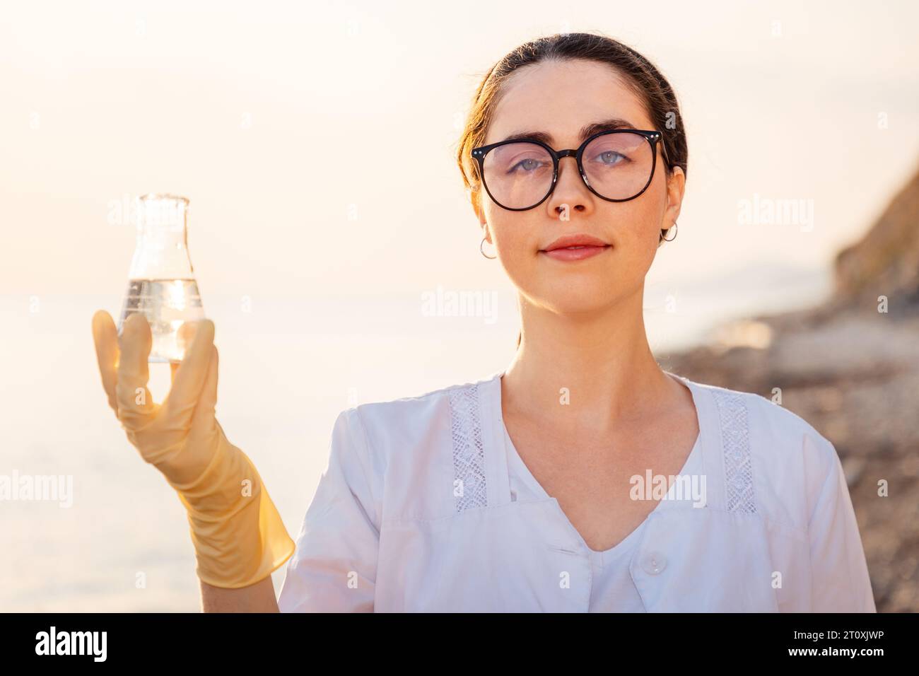 Portrait of pretty woman ecologist wearing protective gloves and ...