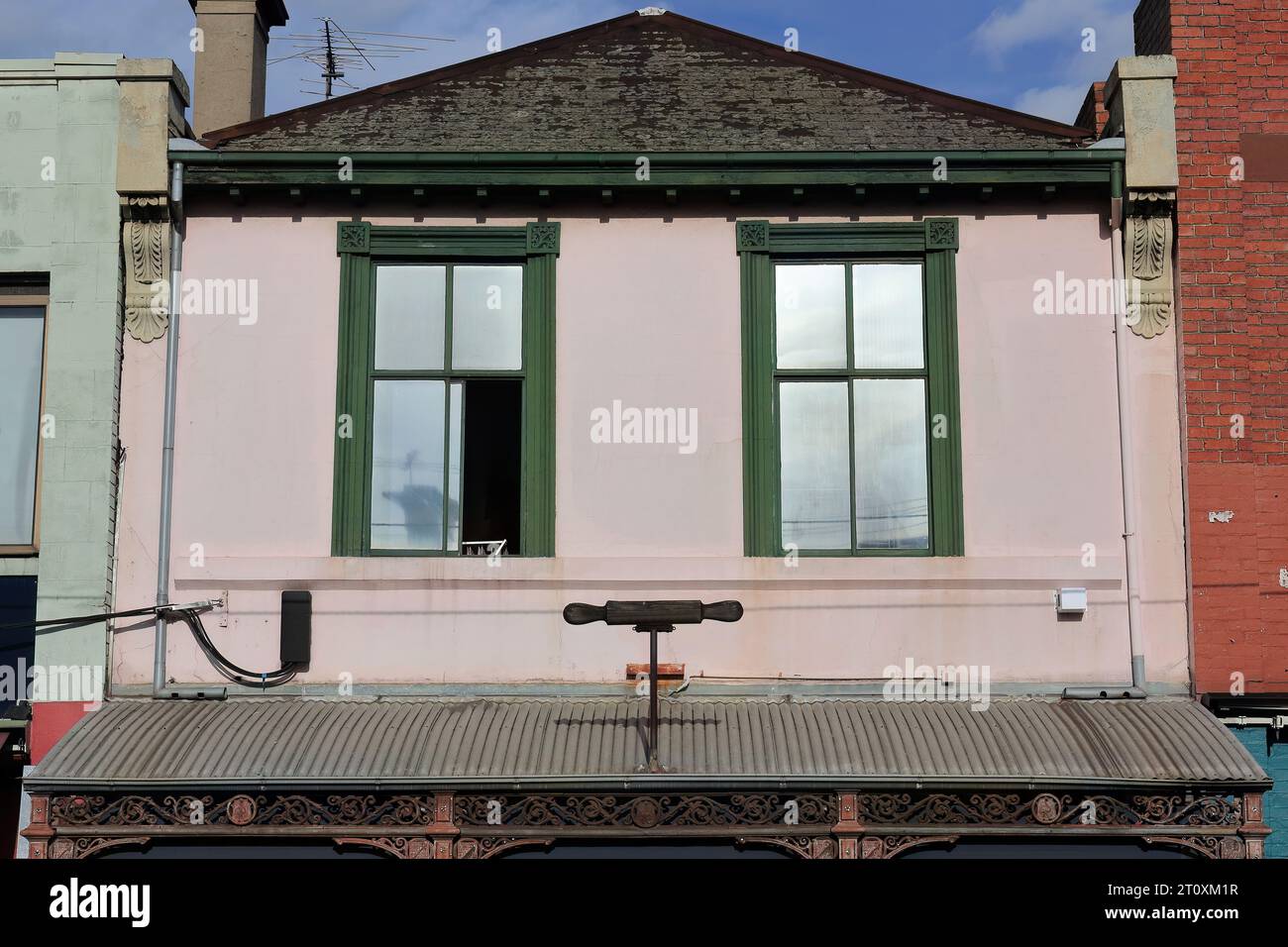997 Pink rendered cement wall and pitched slate roof of Victorian ...