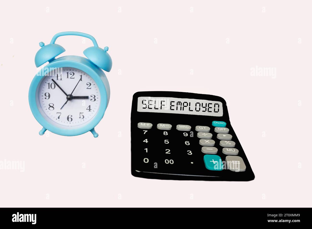 Calculator with text Self Employed on a white background with a clock ...