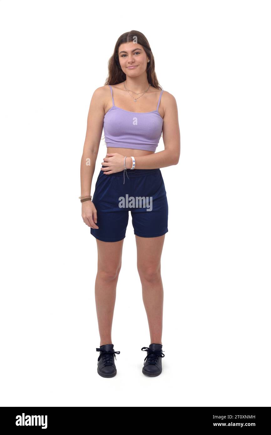 front view of a young girl standing looking at camera on white ...