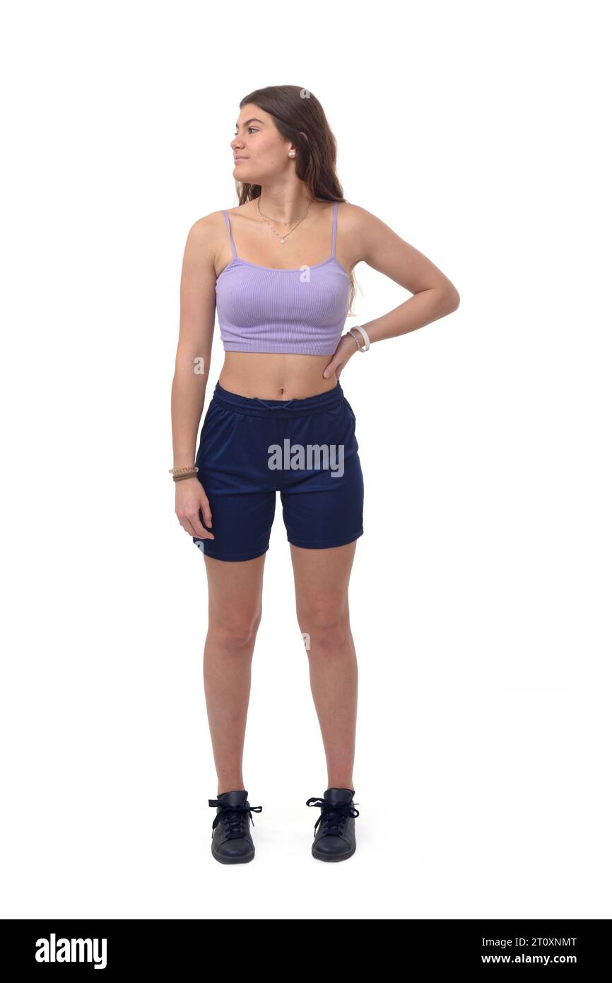 front view of a young girl standing with arm akimbo and looking side on ...