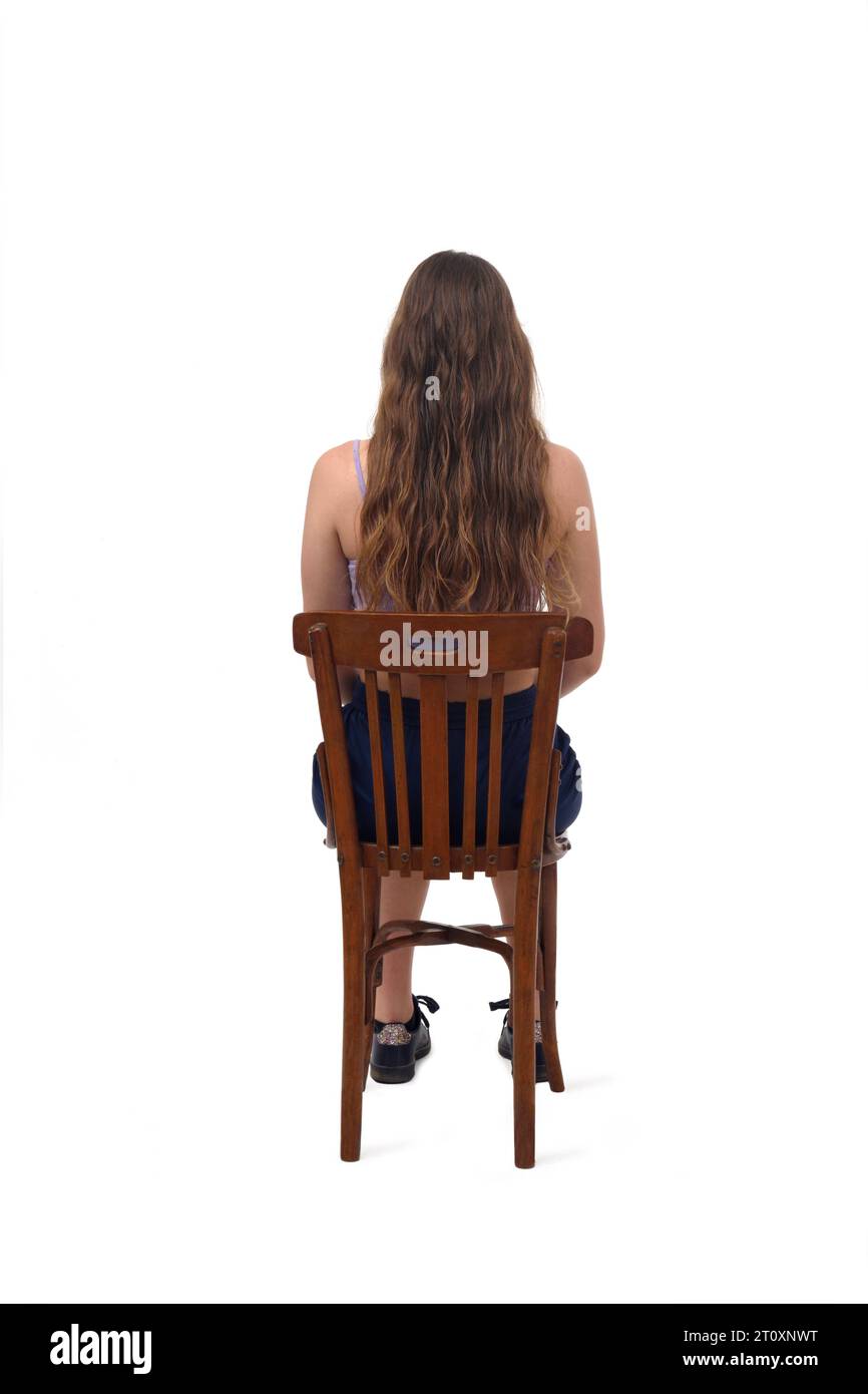 back view of a young girl sitting on chair on white background Stock ...