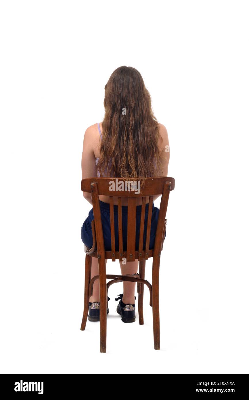 back view of a young girl sitting on chair on white background Stock ...