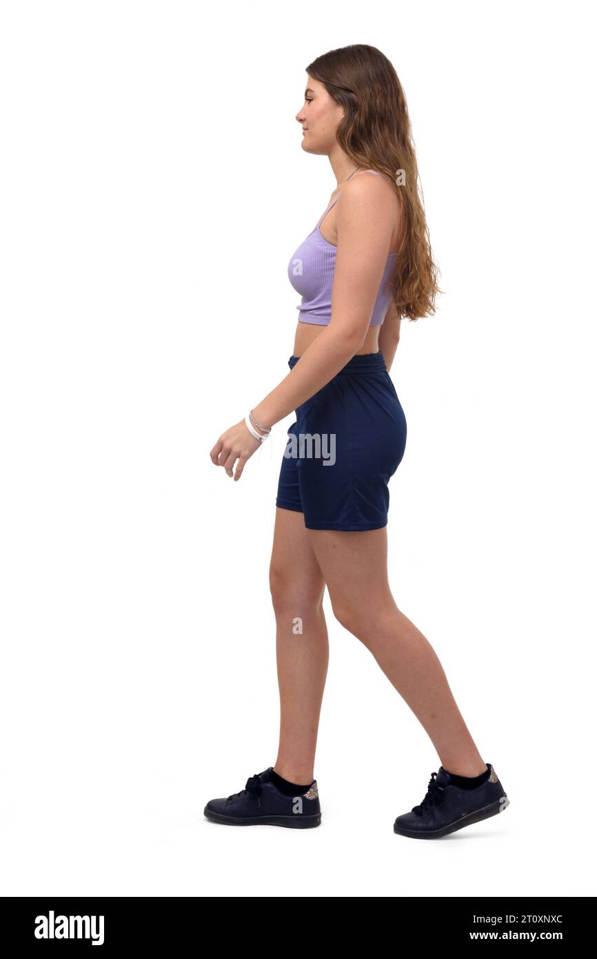 side view of a young girl walking on white background Stock Photo - Alamy