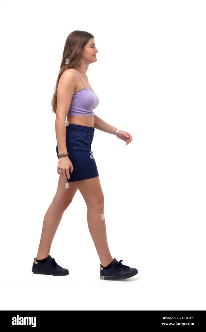 side view of a young girl walking on white background Stock Photo - Alamy