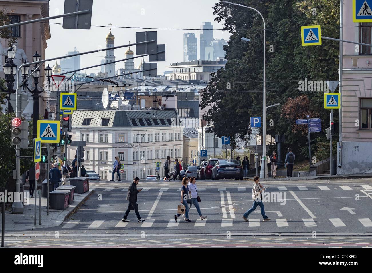 Russia, Moscow. People walk along a pedestrian crossing on one of the ...