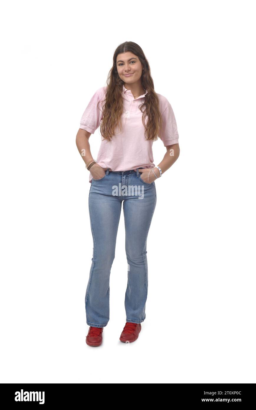 front view of a young girl standing with hands on pockets on white ...