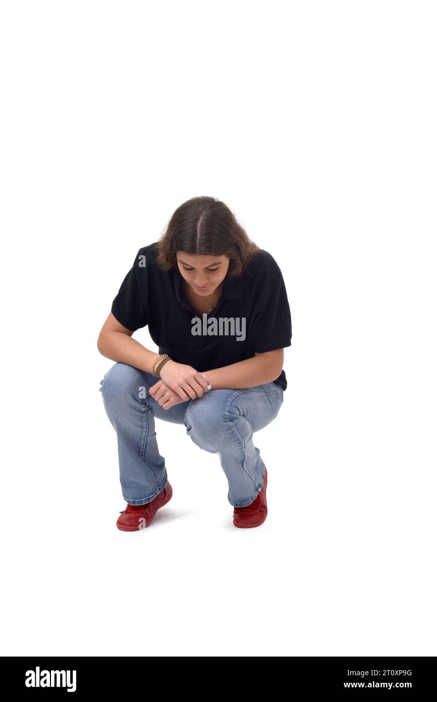 front view of a young girl crouching and searching at the ground on ...