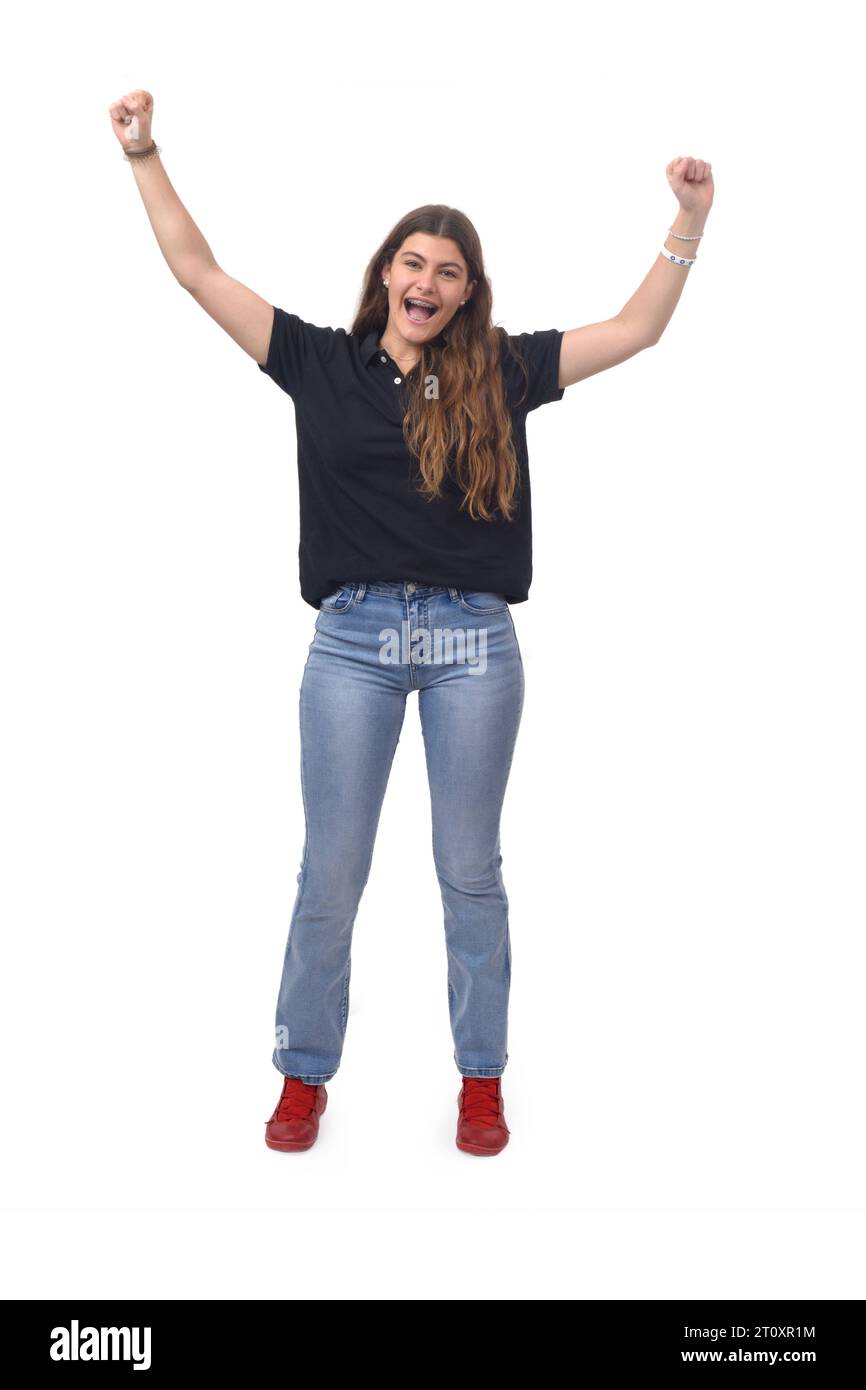 front view of a happy young girl with arms raised on white background ...
