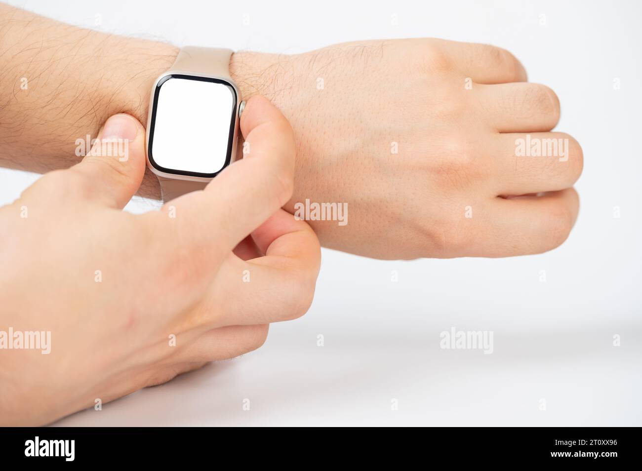 Using smartwatch with one hand isolated on white studio background ...