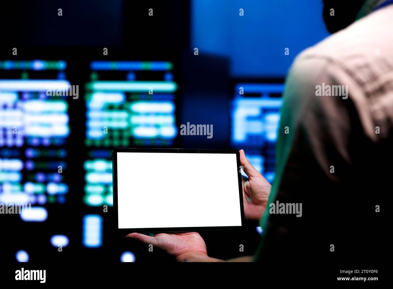 Skillful serviceman conducting annual auditing of data center servers using mock up tablet to ...