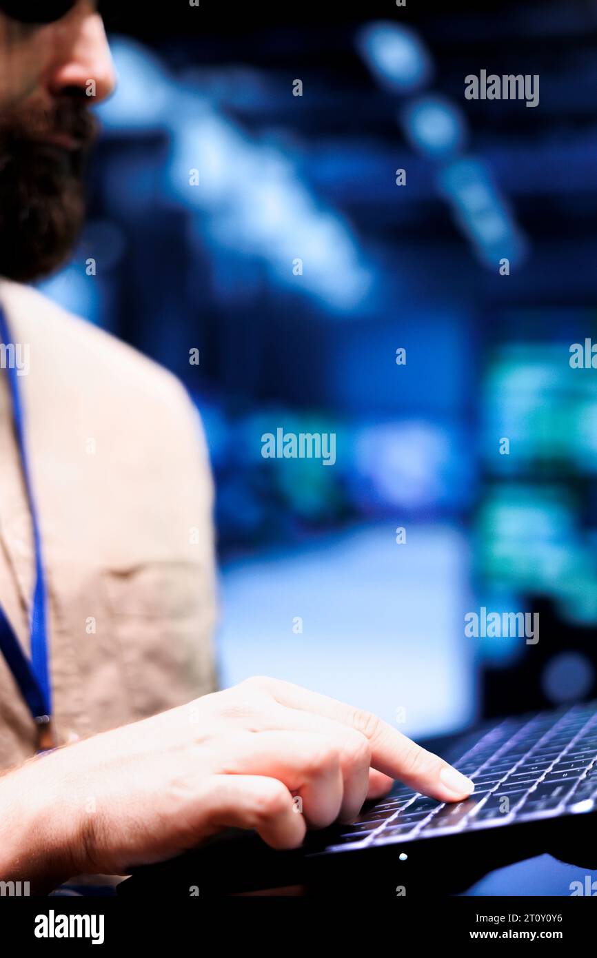 Engineer working in crypto mining facility with servers solving complex ...